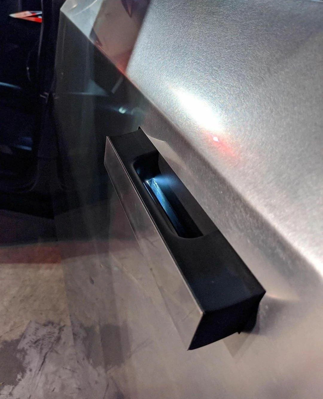 Closeup of Cybertruck door handle and cold-rolled steel body surface ...